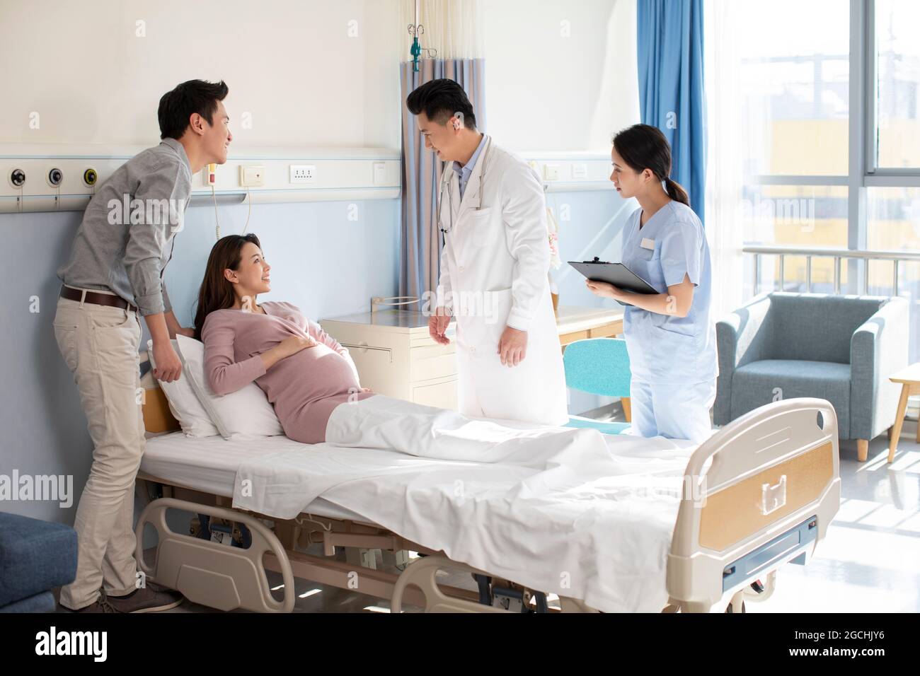 Doctor examining pregnant woman in hospital ward Stock Photo - Alamy