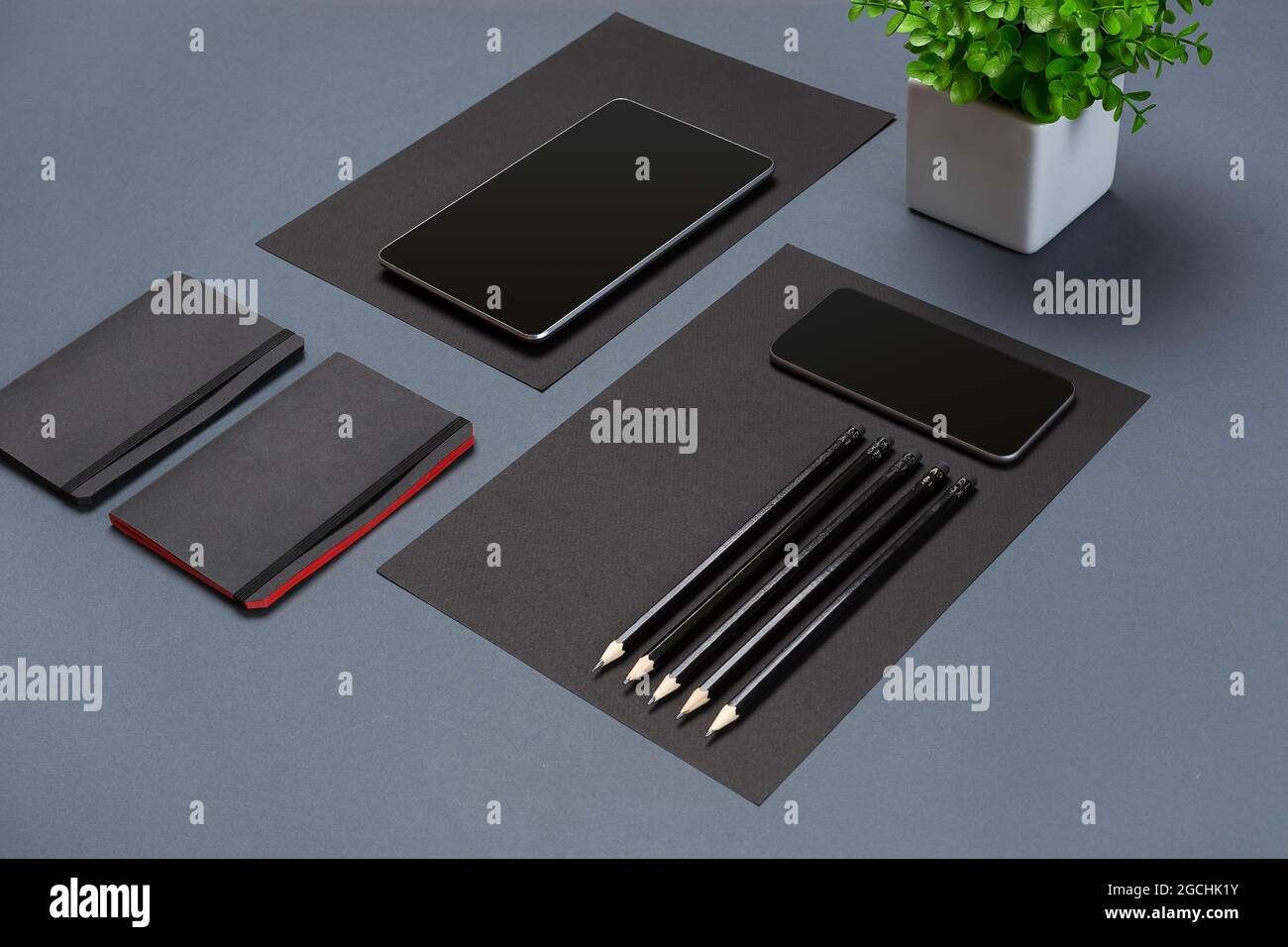 Modern mock up flat lay of notebook and stationery on gray background ...