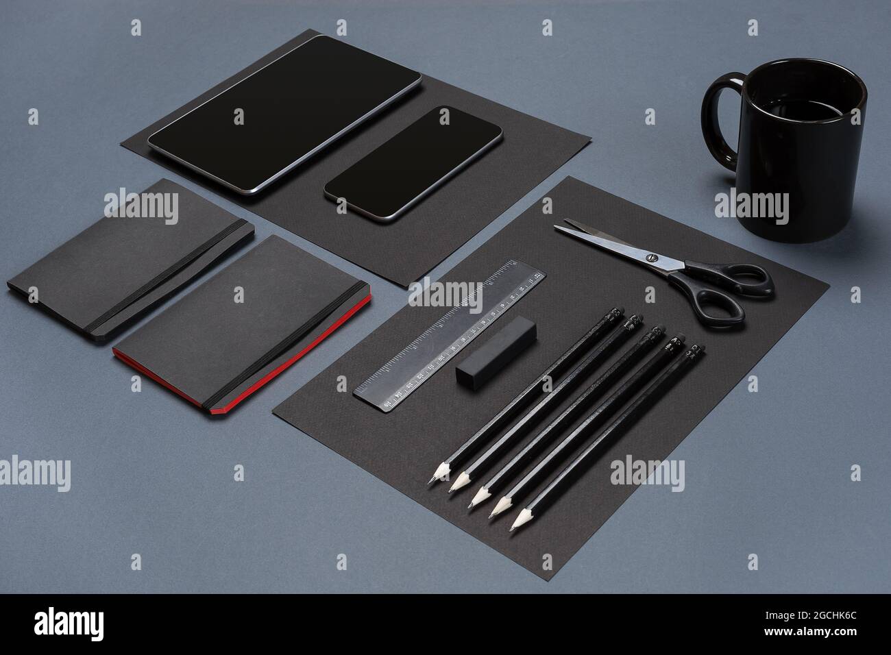Flat lay of blank black paper sheet, black stationery items and coffee ...