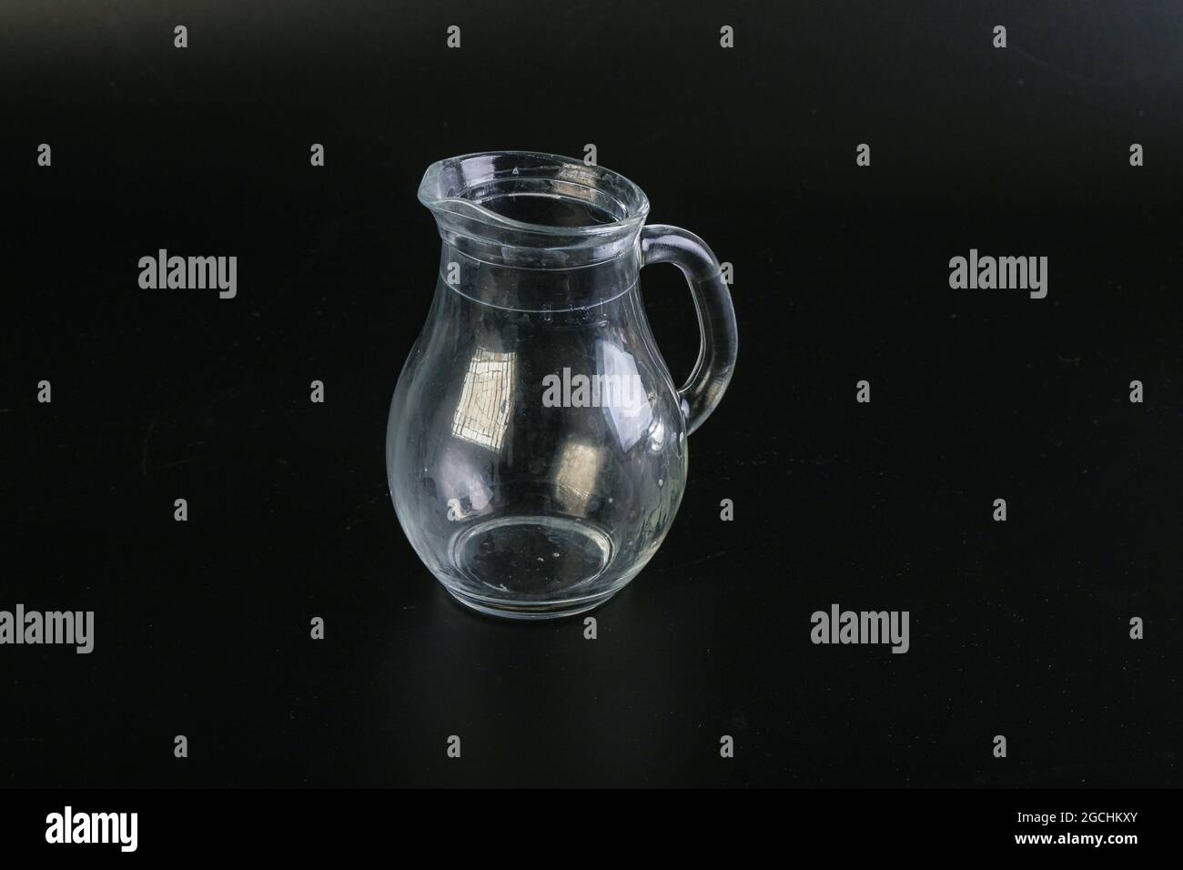 Empty glass jug for liquid isolated Stock Photo - Alamy