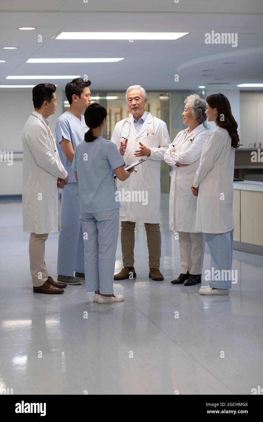 Doctors talking in hospital corridor Stock Photo - Alamy
