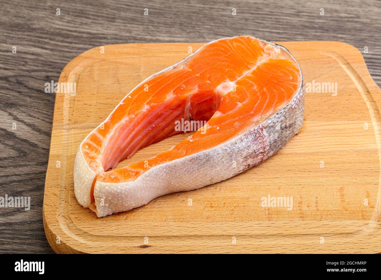 Raw salmon steak over board for cooking Stock Photo - Alamy