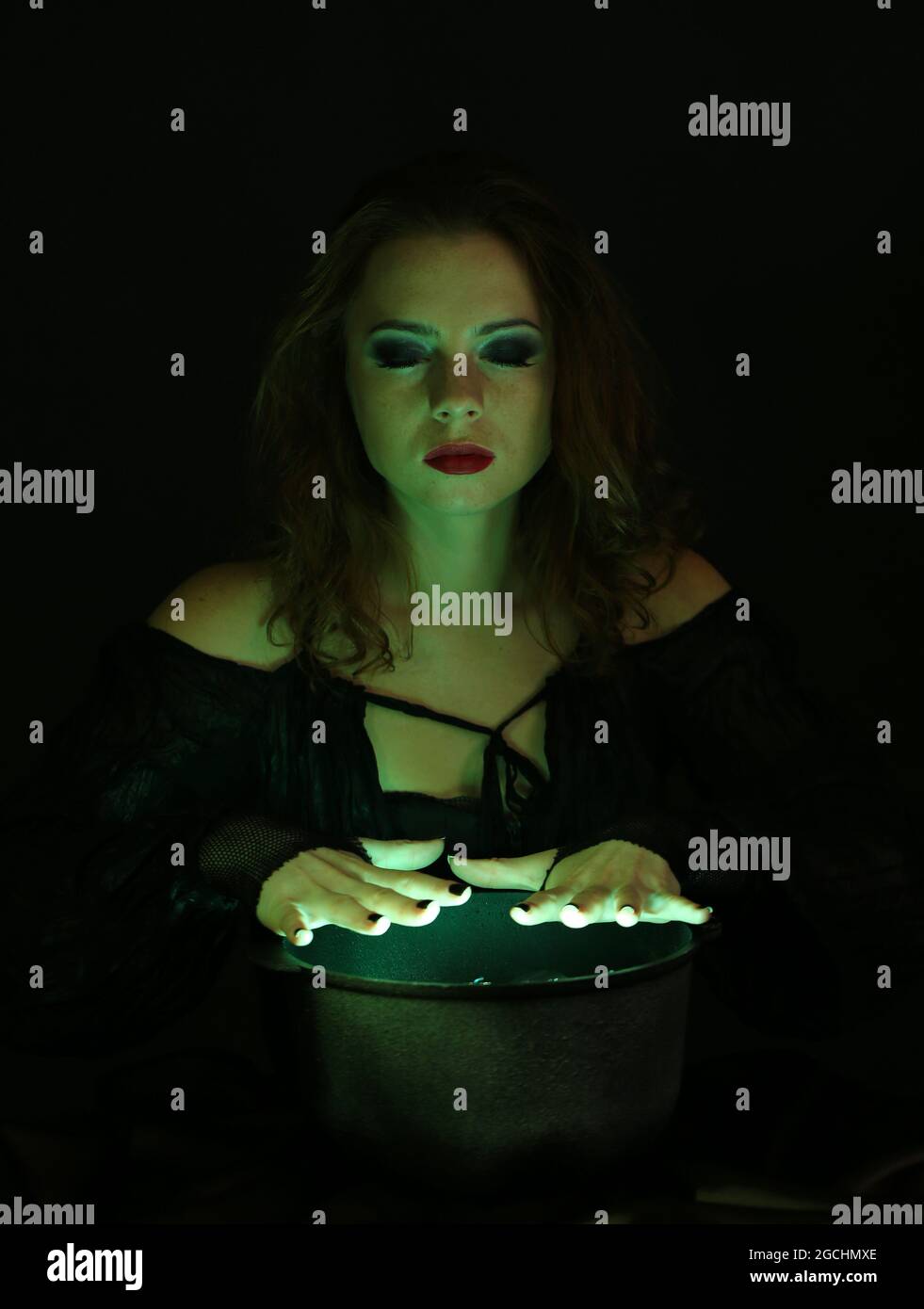 Halloween witch on black background Stock Photo - Alamy