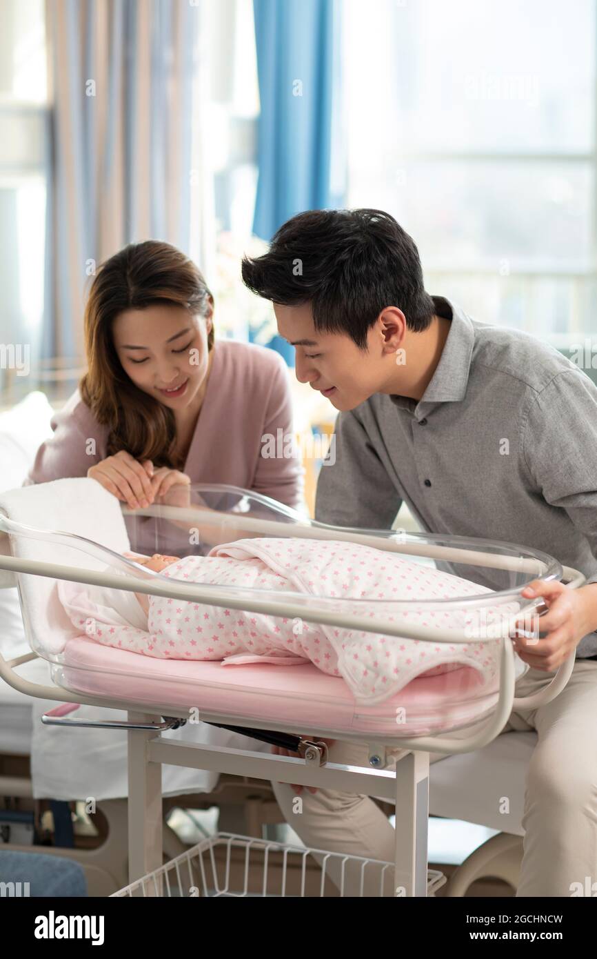 Parents with newborn baby in hospital ward Stock Photo - Alamy