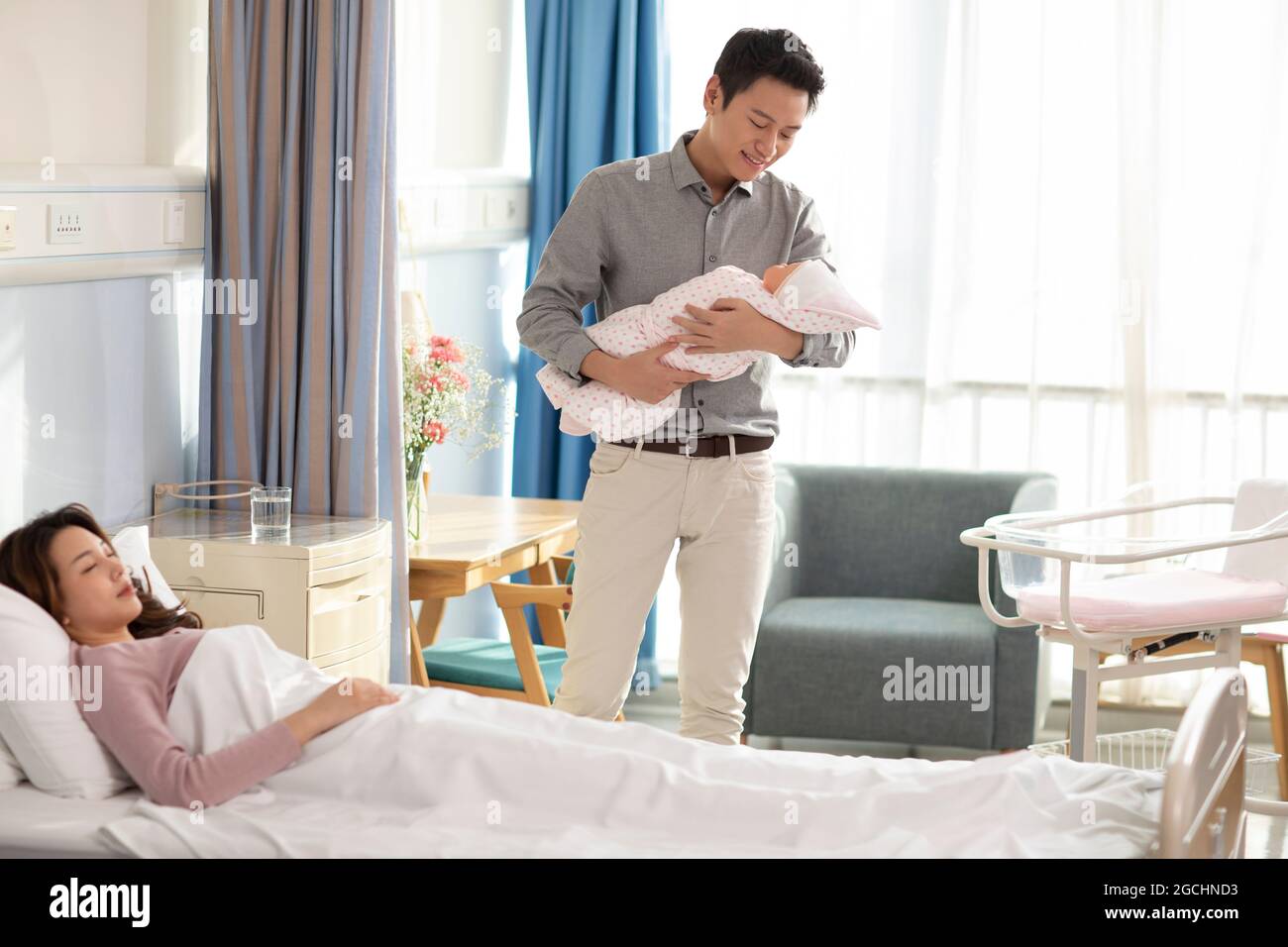 Parents with newborn baby in hospital ward Stock Photo - Alamy