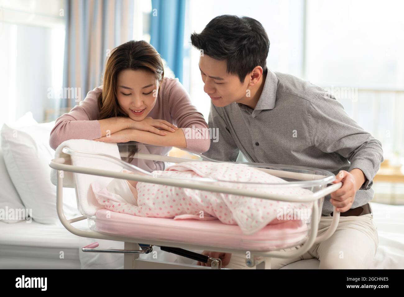 Parents with newborn baby in hospital ward Stock Photo - Alamy