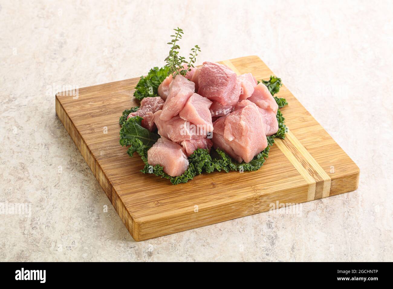 Raw pork meat cubes for coocking over board Stock Photo - Alamy