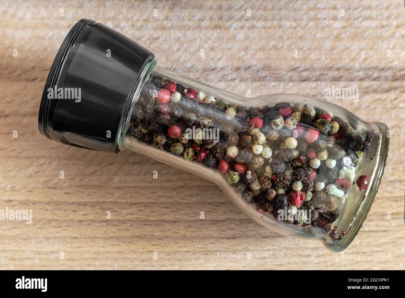 Various varieties of pepper in a glass bottle Stock Photo - Alamy