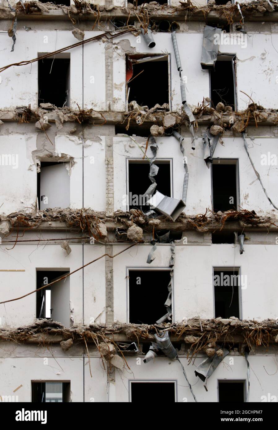 Tall building being demolished exposing cables and metal beams Stock ...