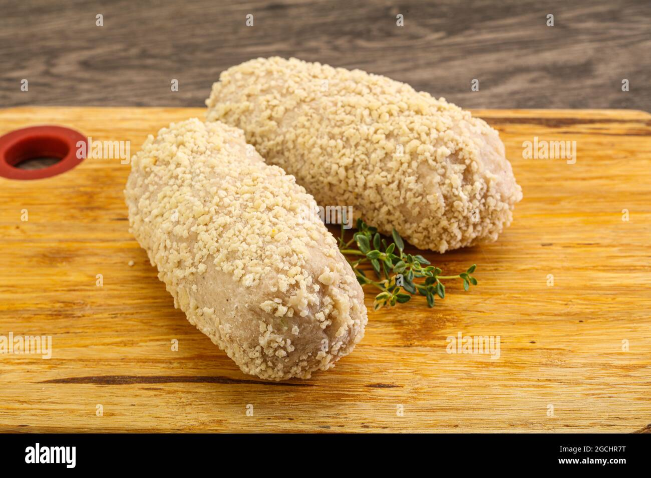 Raw breaded chicken cutlet for roast Stock Photo - Alamy