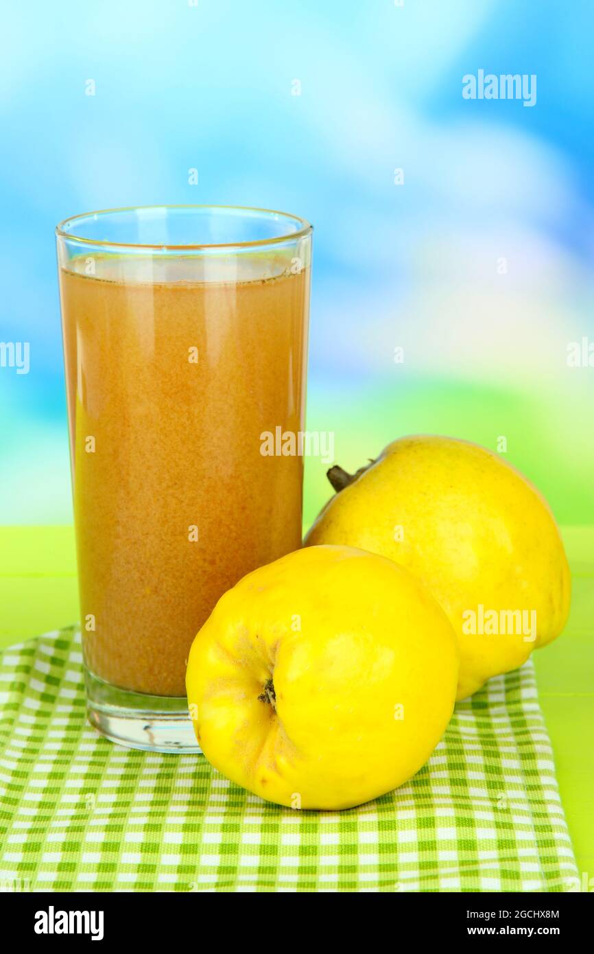 Sweet quince with juice on table on light blue background Stock Photo ...