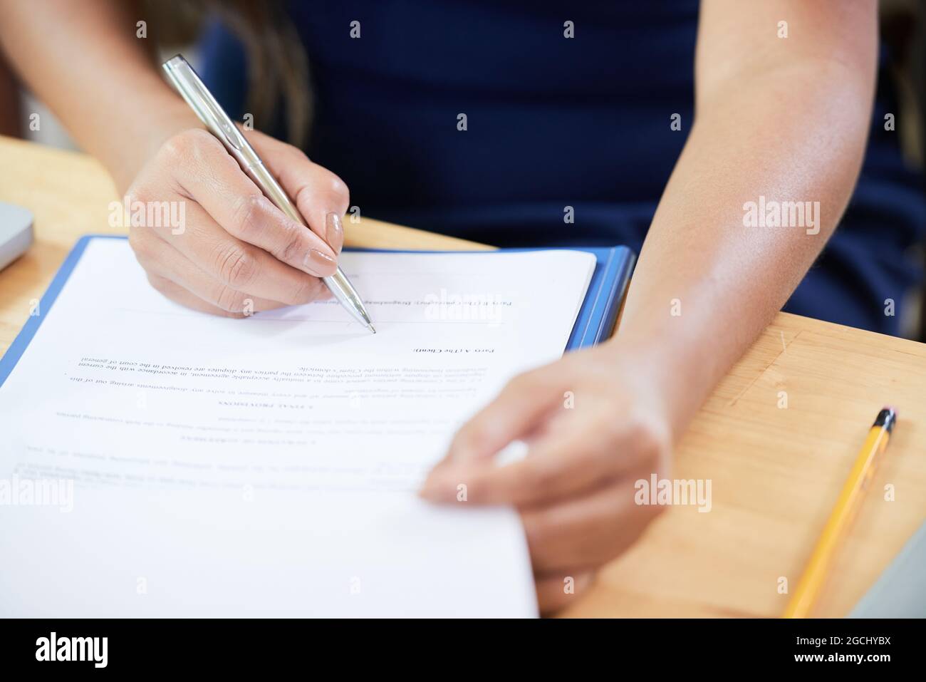 Hands of female entrepreneur working at her office desk and signing ...