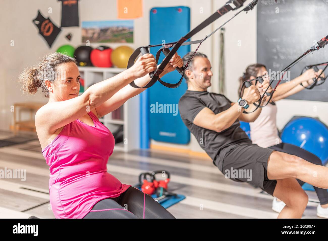 Woman exercises suspension straps hi-res stock photography and images ...