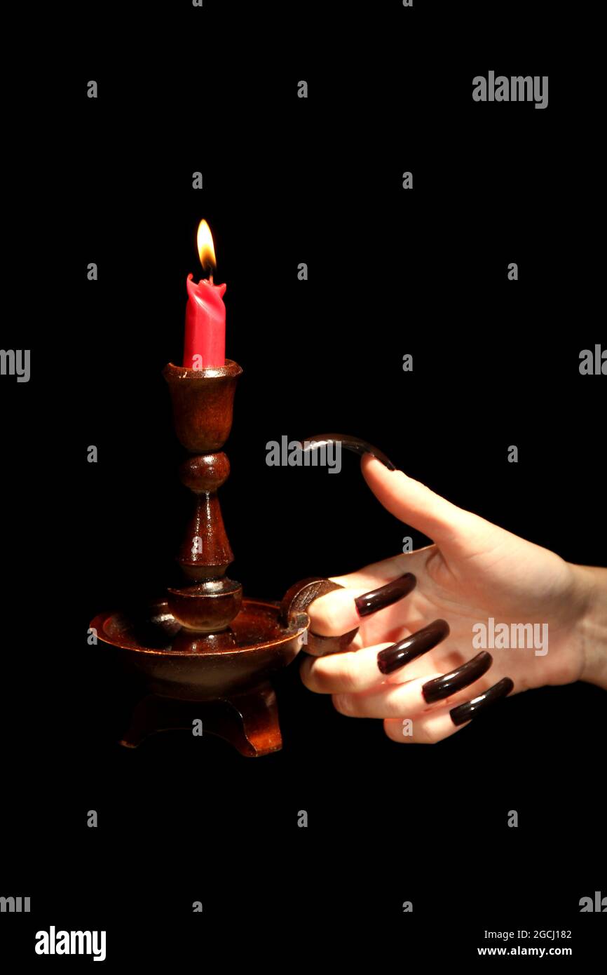 Hand with candle , isolated on black Stock Photo - Alamy