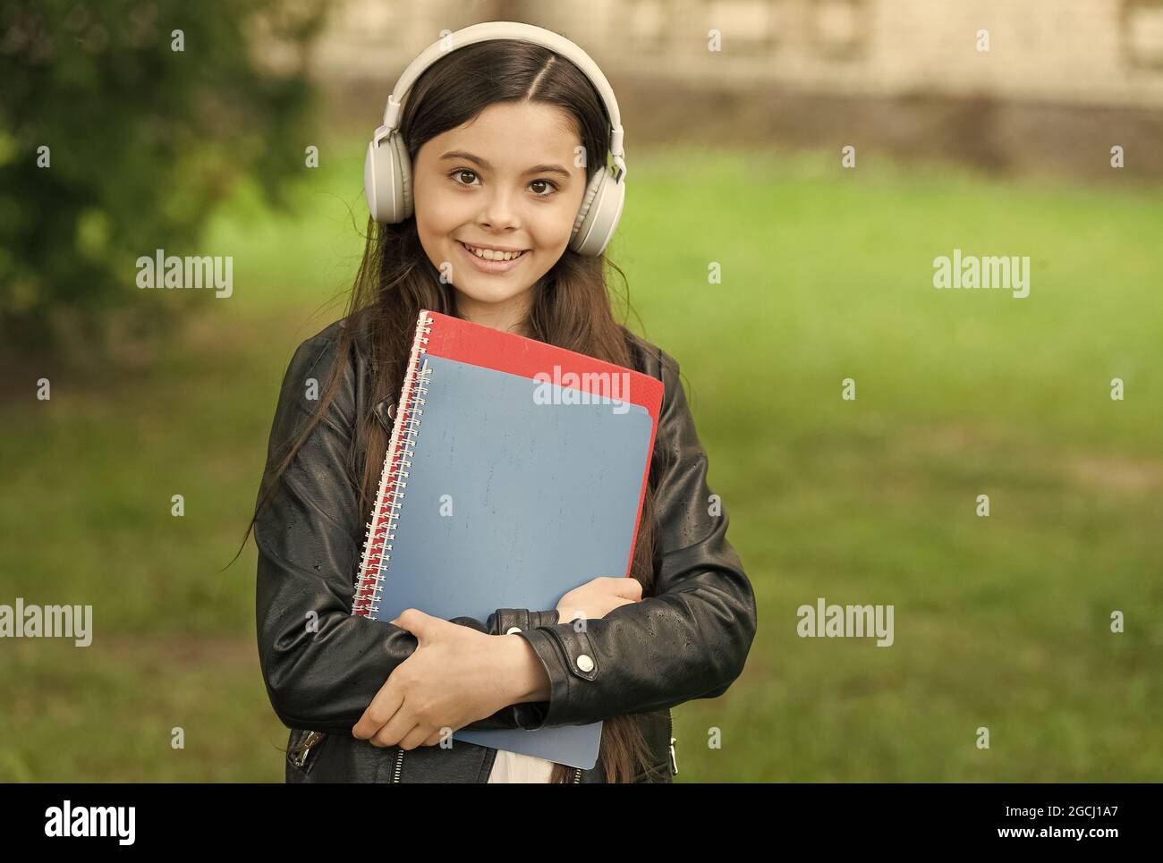 Girl listening audio carry textbooks on way to school, school club ...