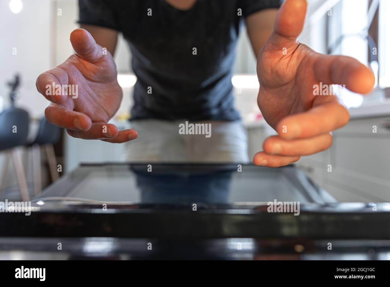 Close-up of male hands take out something from the oven Stock Photo - Alamy