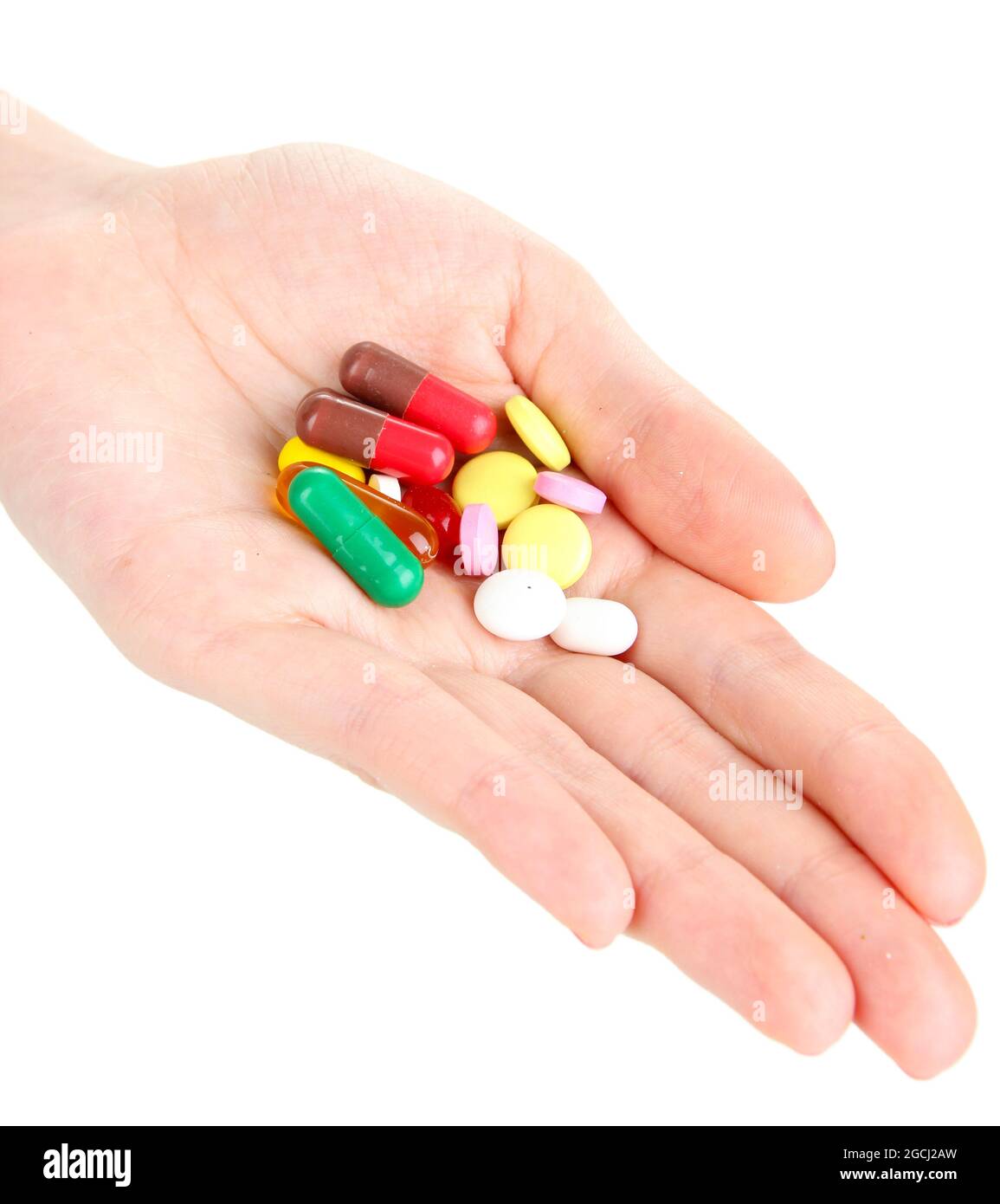 Pills in hand isolated on white Stock Photo - Alamy