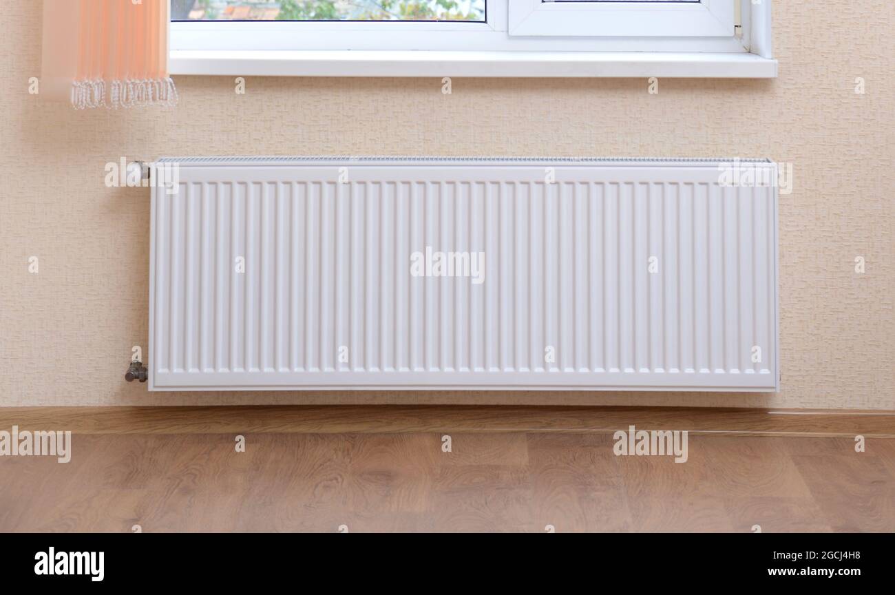 Photo heating radiator under window Stock Photo - Alamy