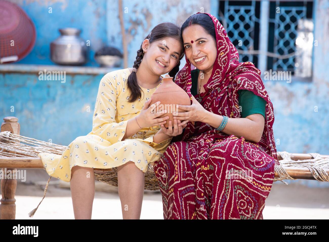 Portrait of happy rural indian mother and adorable daughter holding ... Portrait of happy rural indian mother and adorable daughter holding ...