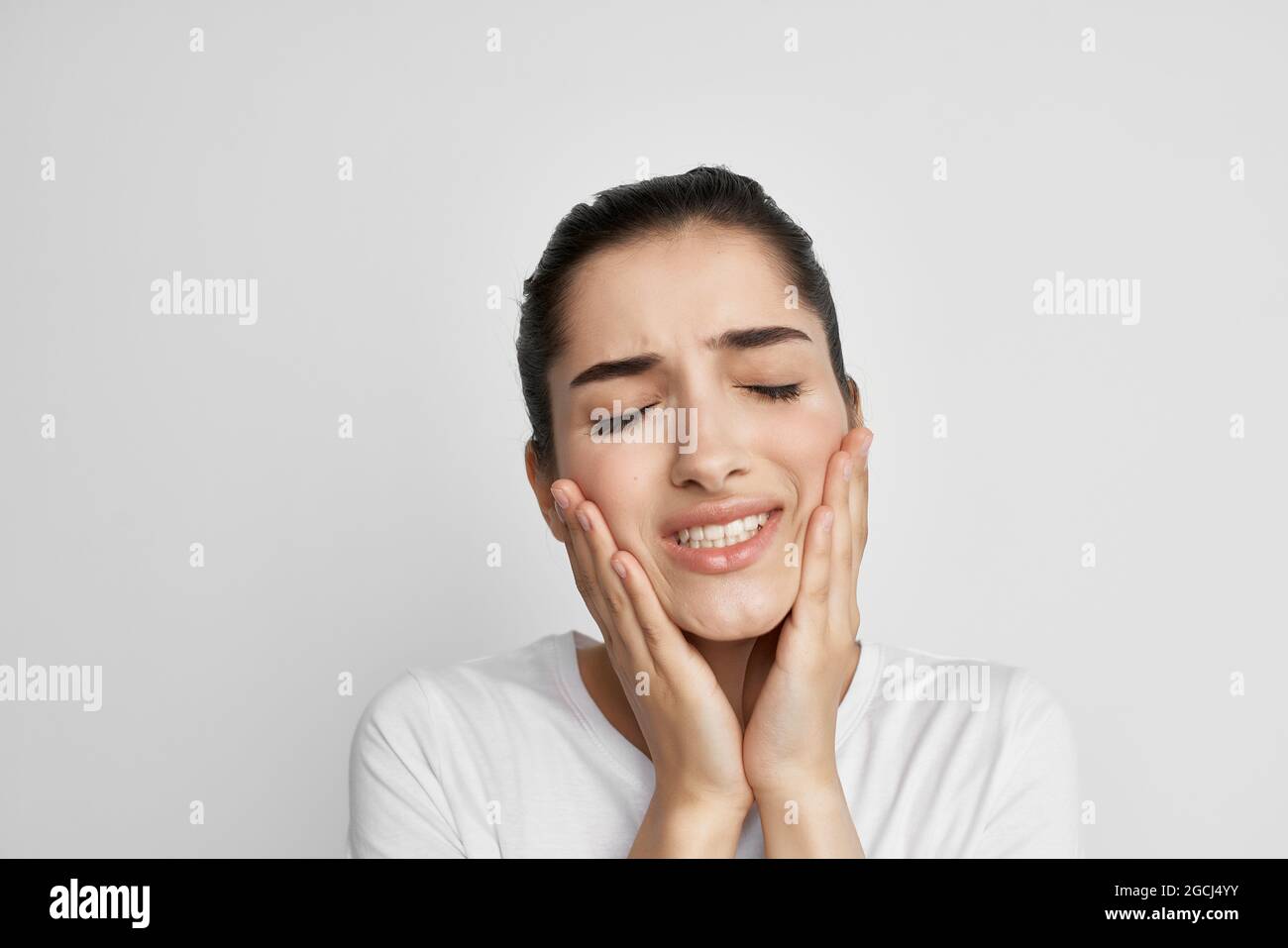 woman holding face toothache discontent discomfort Stock Photo - Alamy