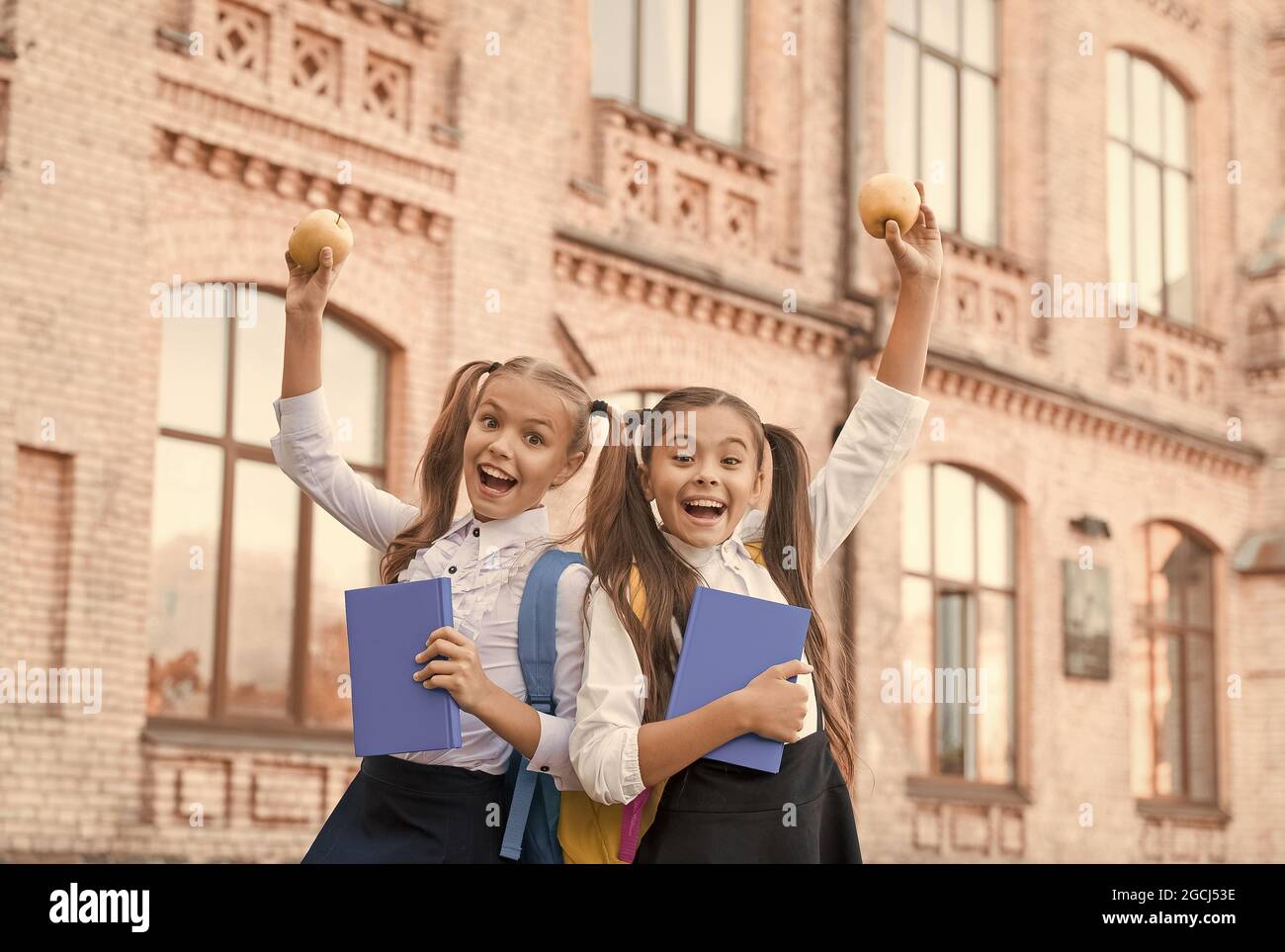 Students girls classmates with backpacks having school lunch, child ...