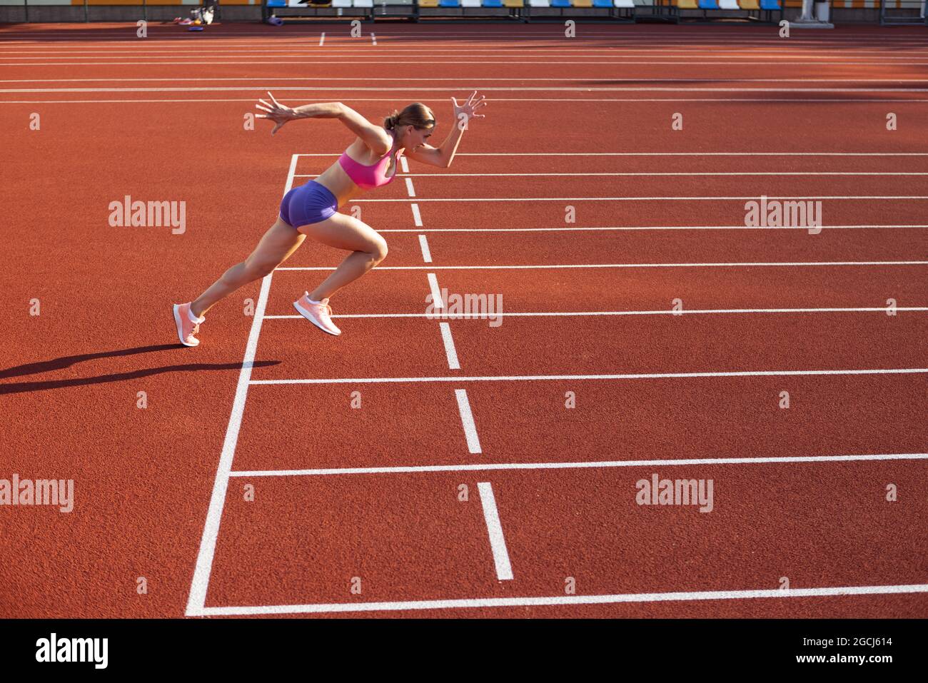 At start line. One Caucasian woman, female athlete, runner training at ...