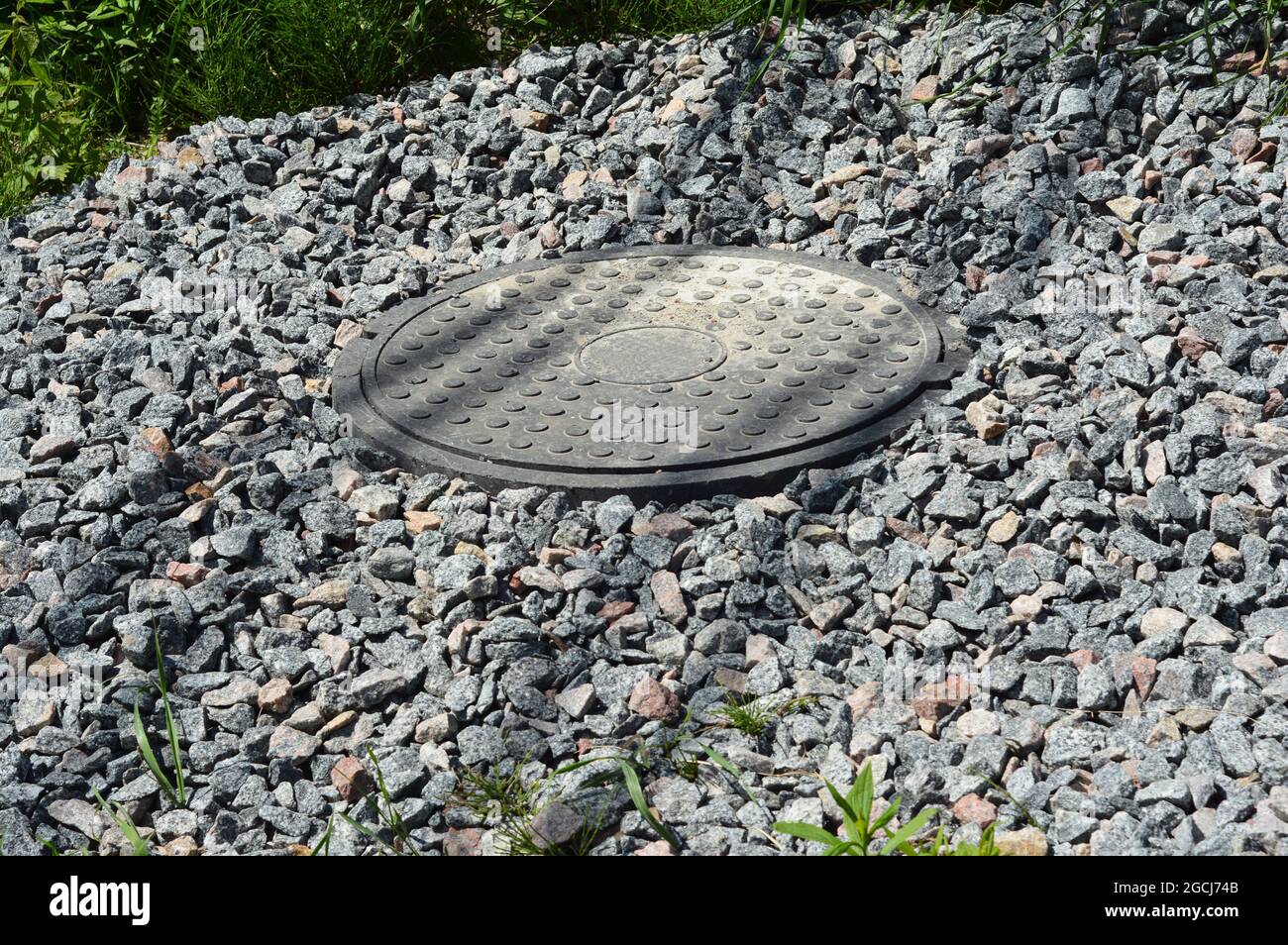 A close-up of a plastic septic tank manhole cover, manhole lid that ...