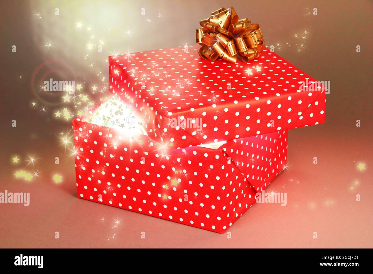 Gift box with bright light on it on bright background Stock Photo - Alamy