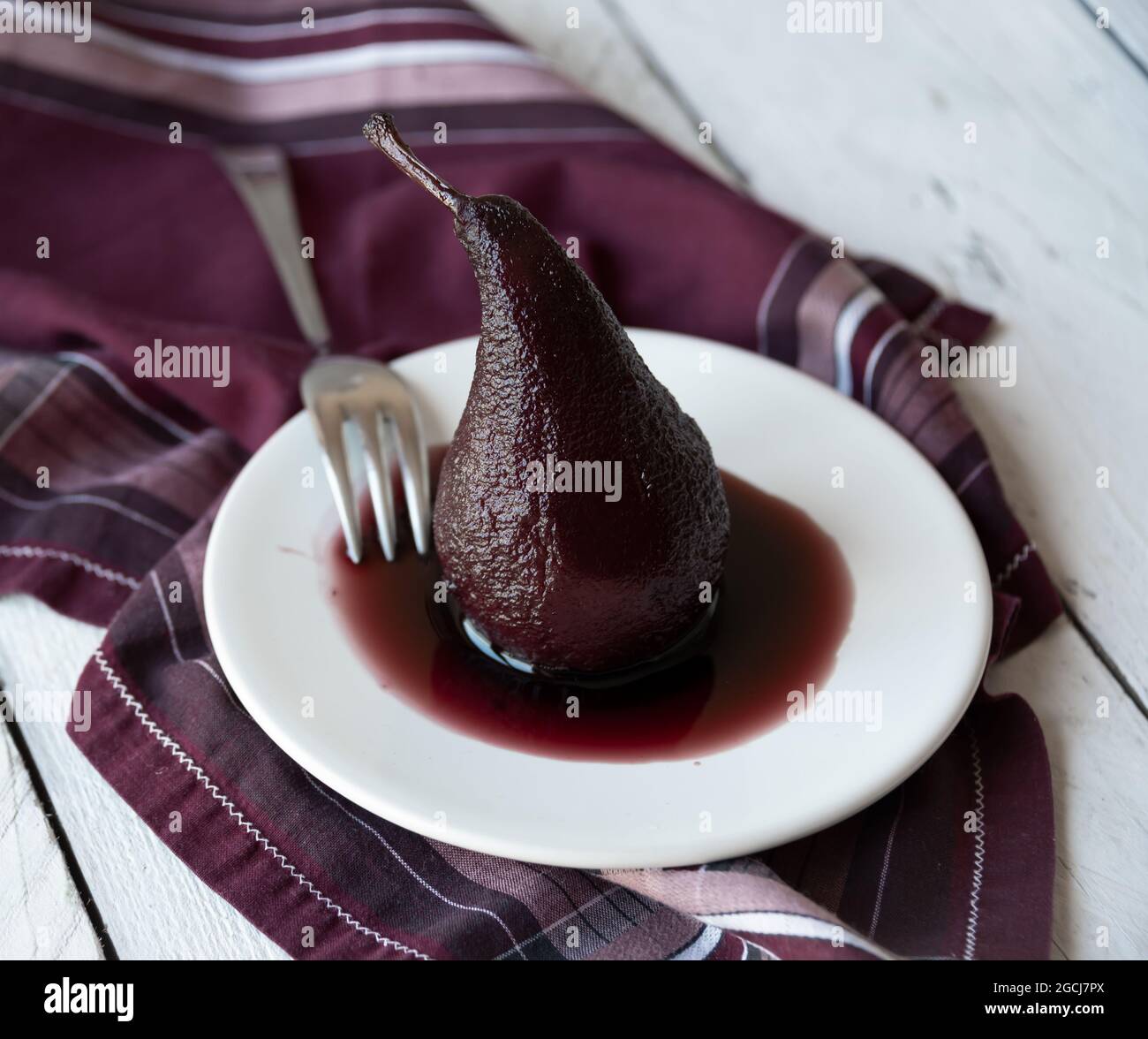Sweet pear cooked with red wine, delicious homemade dessert Stock Photo ...