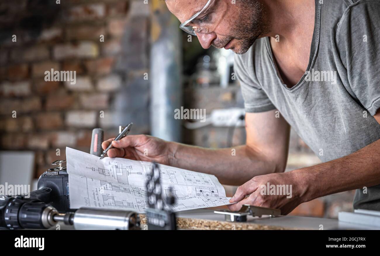 Male joiner in the process of working with wood in the workshop Stock ...