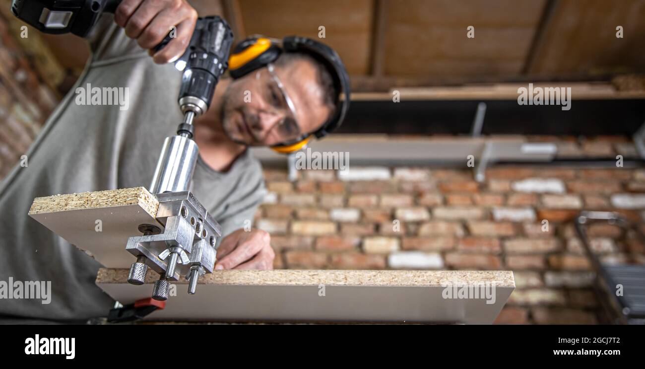 Professional carpenter working with wood and building tools in house ...