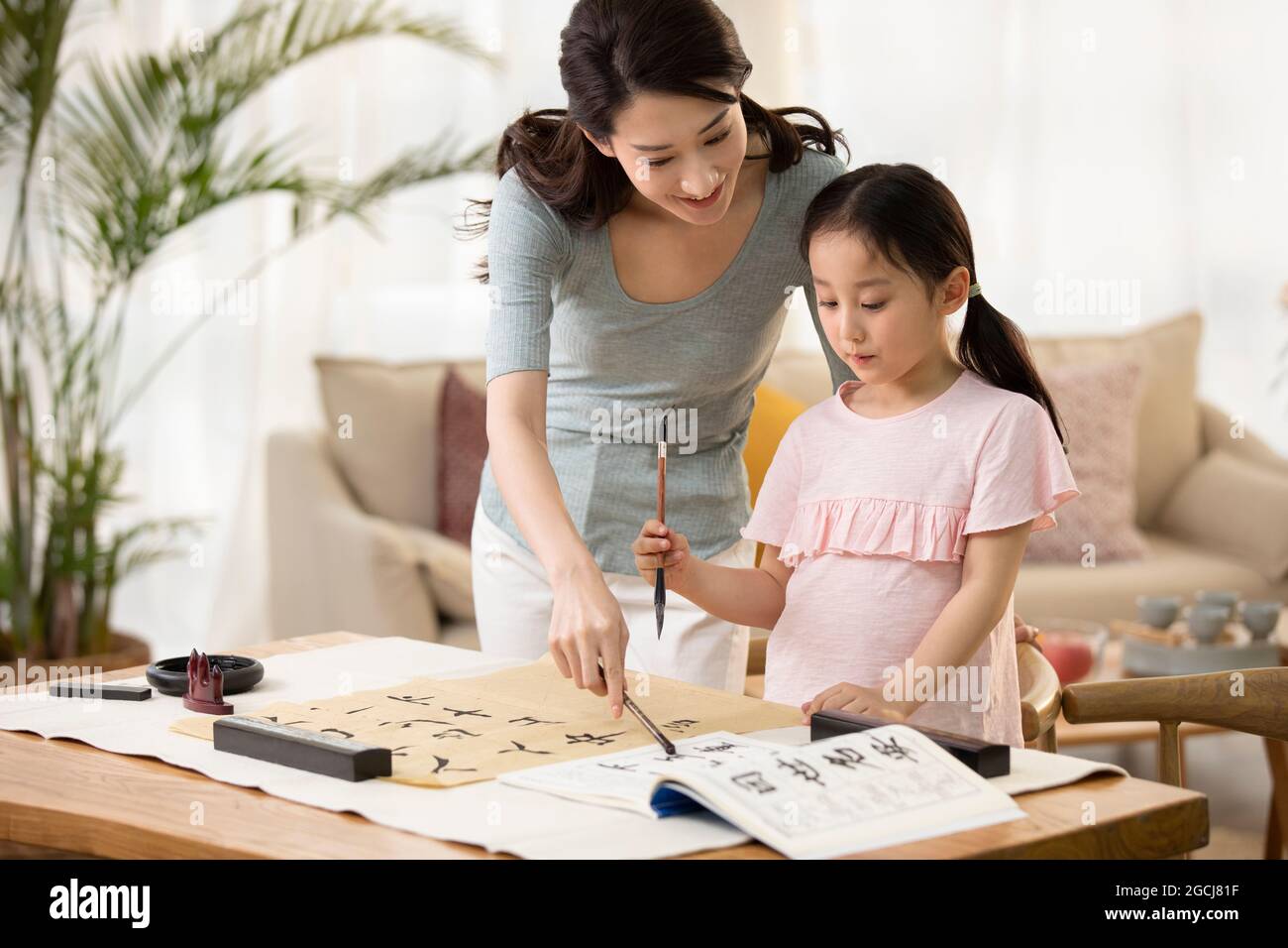 Child learning calligraphy chinese hi-res stock photography and images ...