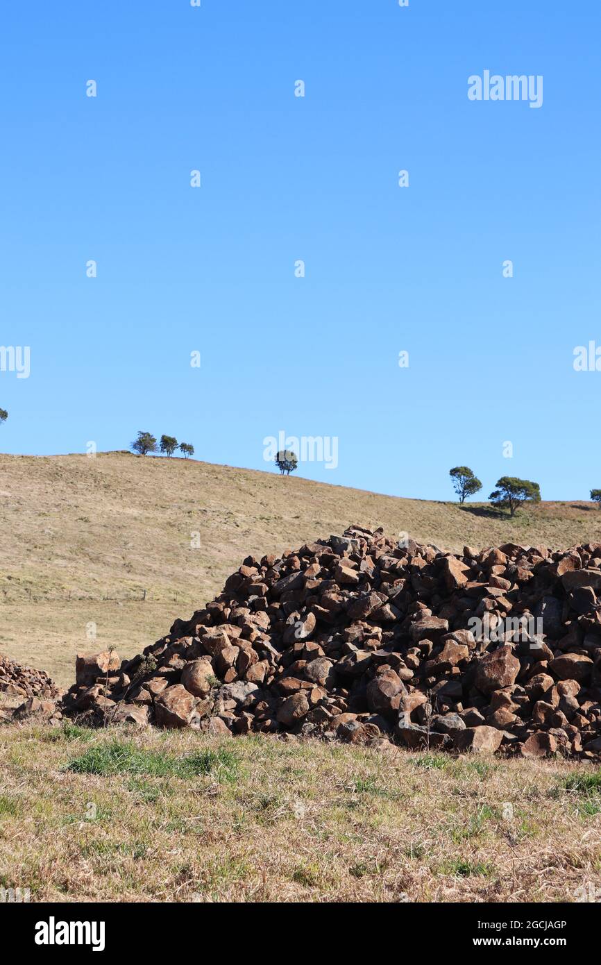 Vertical shot of a stone mound and a beautiful landscape in Southern ...