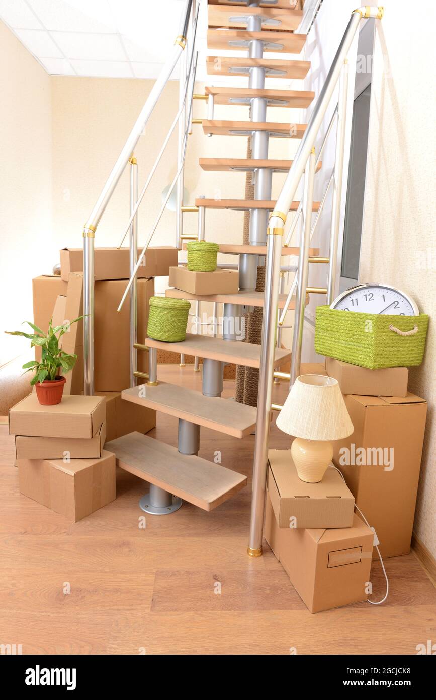 Stack of cartons near stairs: moving house concept Stock Photo - Alamy