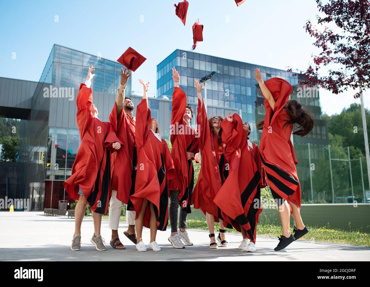 Group of cheerful university students celebrating outdoors, graduation ...