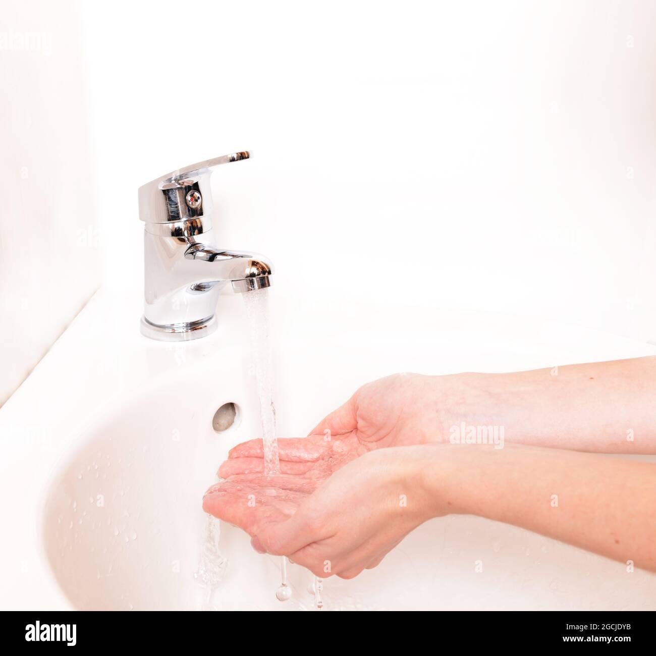 Close-up of human hands being washed under faucet in bathroom Stock ...