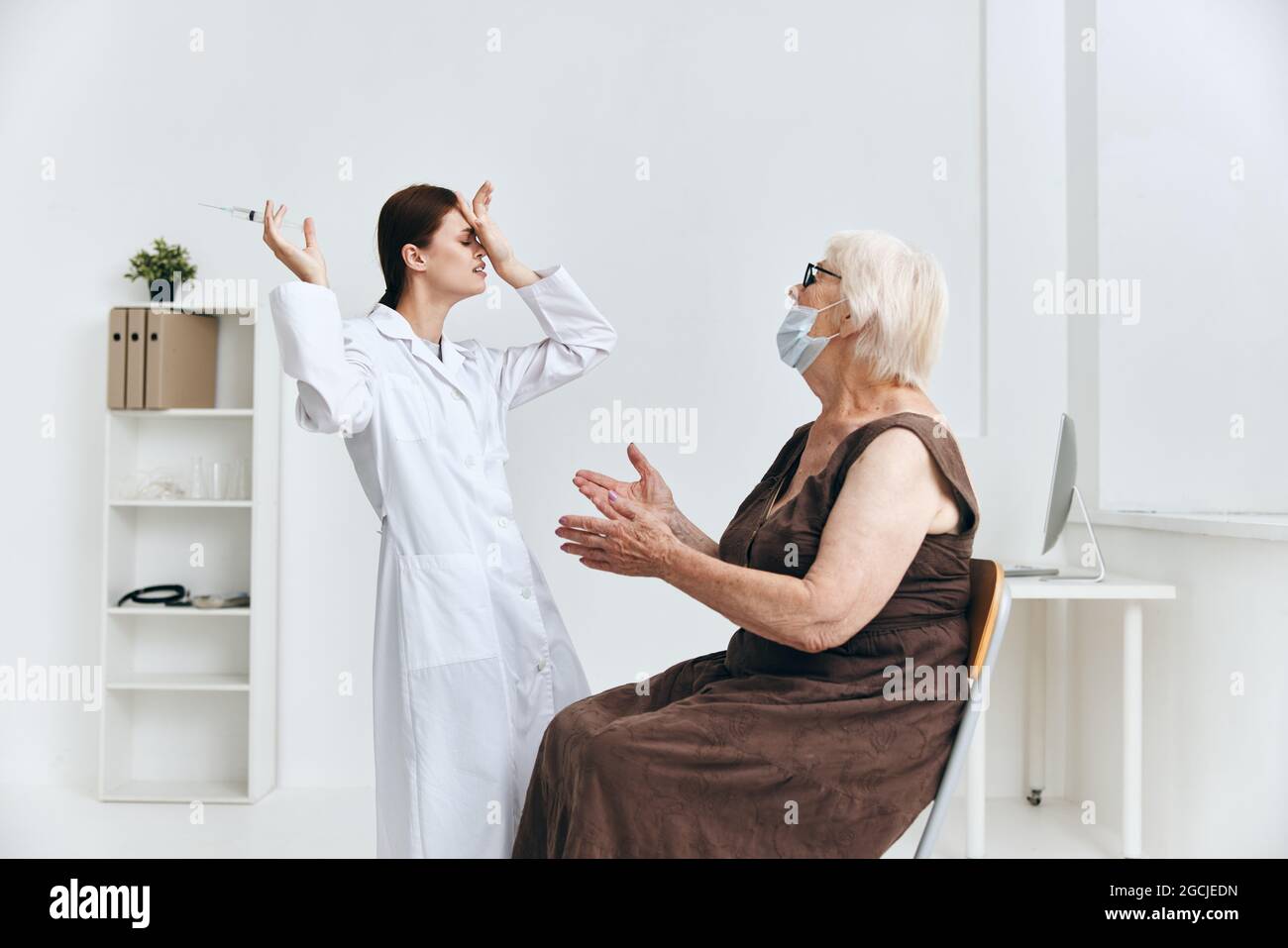 old woman at the doctor's appointment syringe injection fun Stock Photo ...