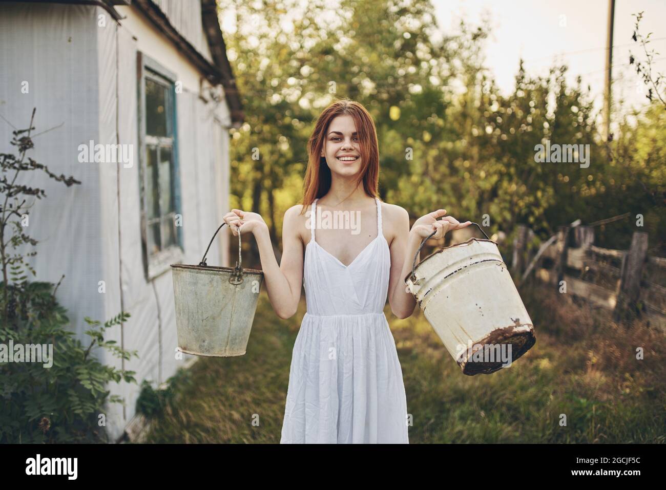 woman in white dress work in the village Sun freedom Stock Photo - Alamy