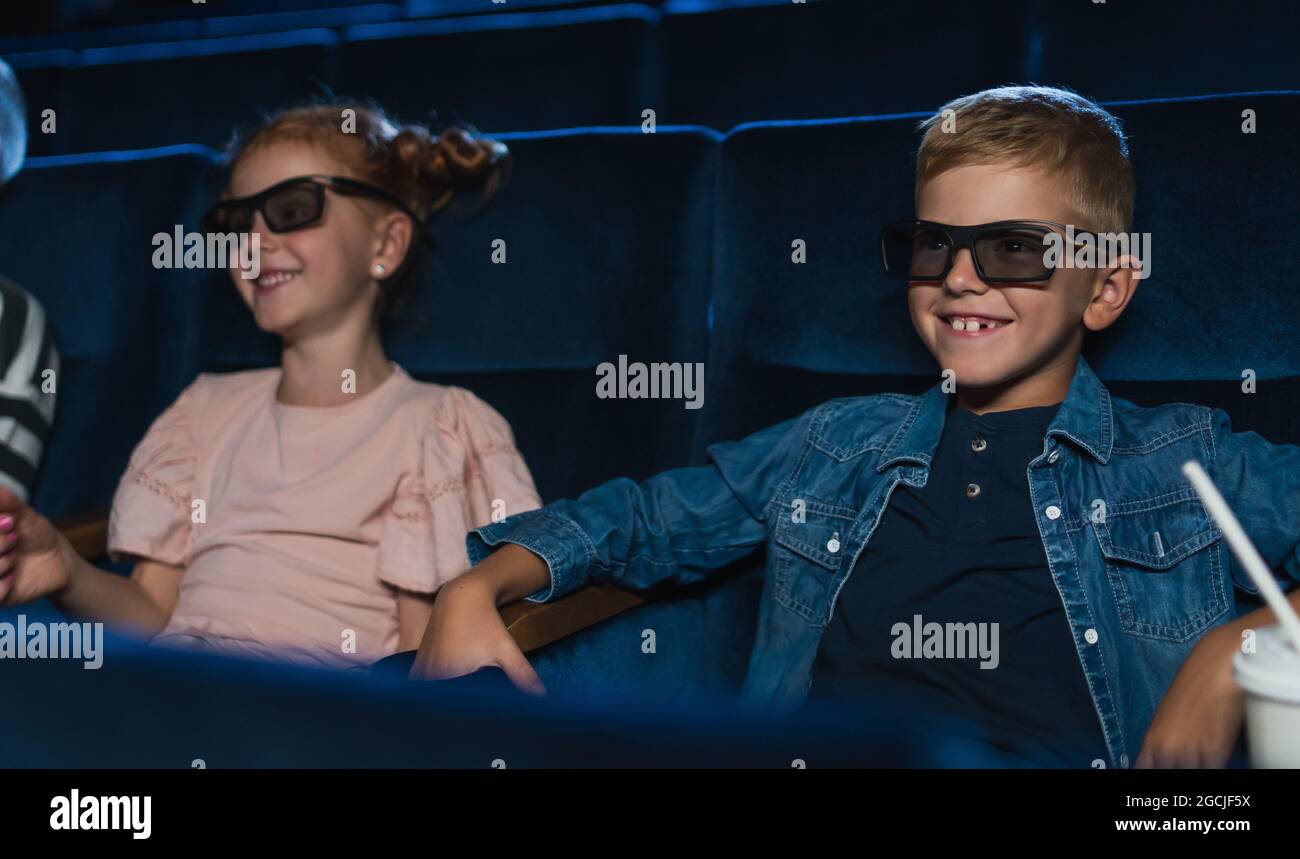 Happy small children with 3d glasses in the cinema, watching film Stock ...