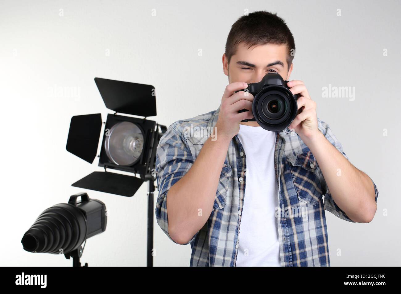 Handsome photographer with camera, on photo studio background Stock ...