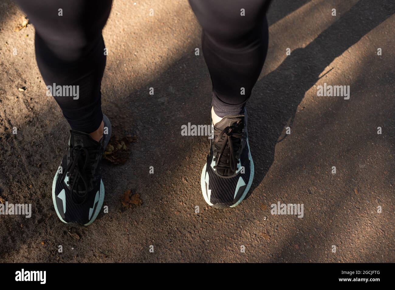 Woman running legs on the asphalt road Stock Photo - Alamy