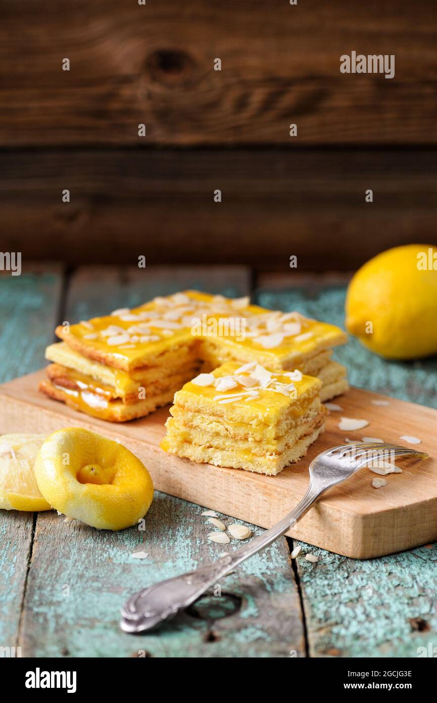 Homemade tasty layered lemon cake with tea and lemon curd on shabby ...