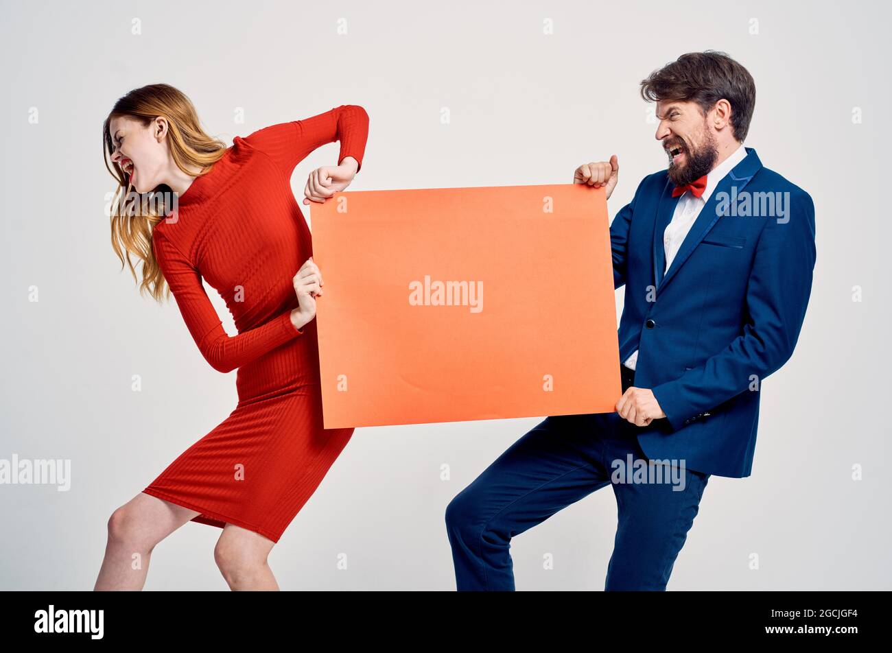 national man and woman holding on to mocap poster advertising Stock ...