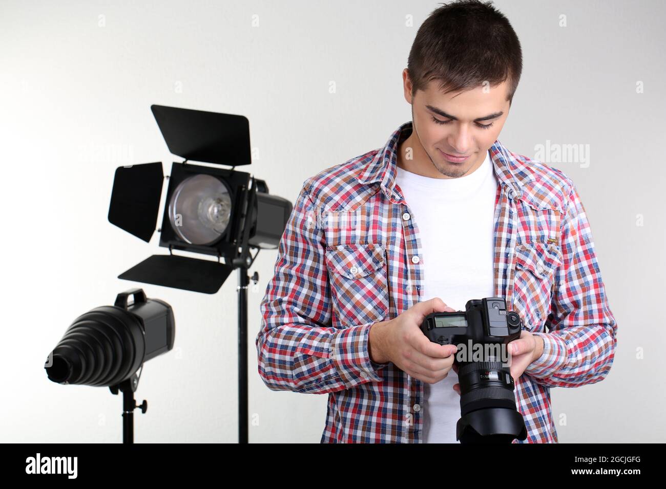 Handsome photographer with camera, on photo studio background Stock ...