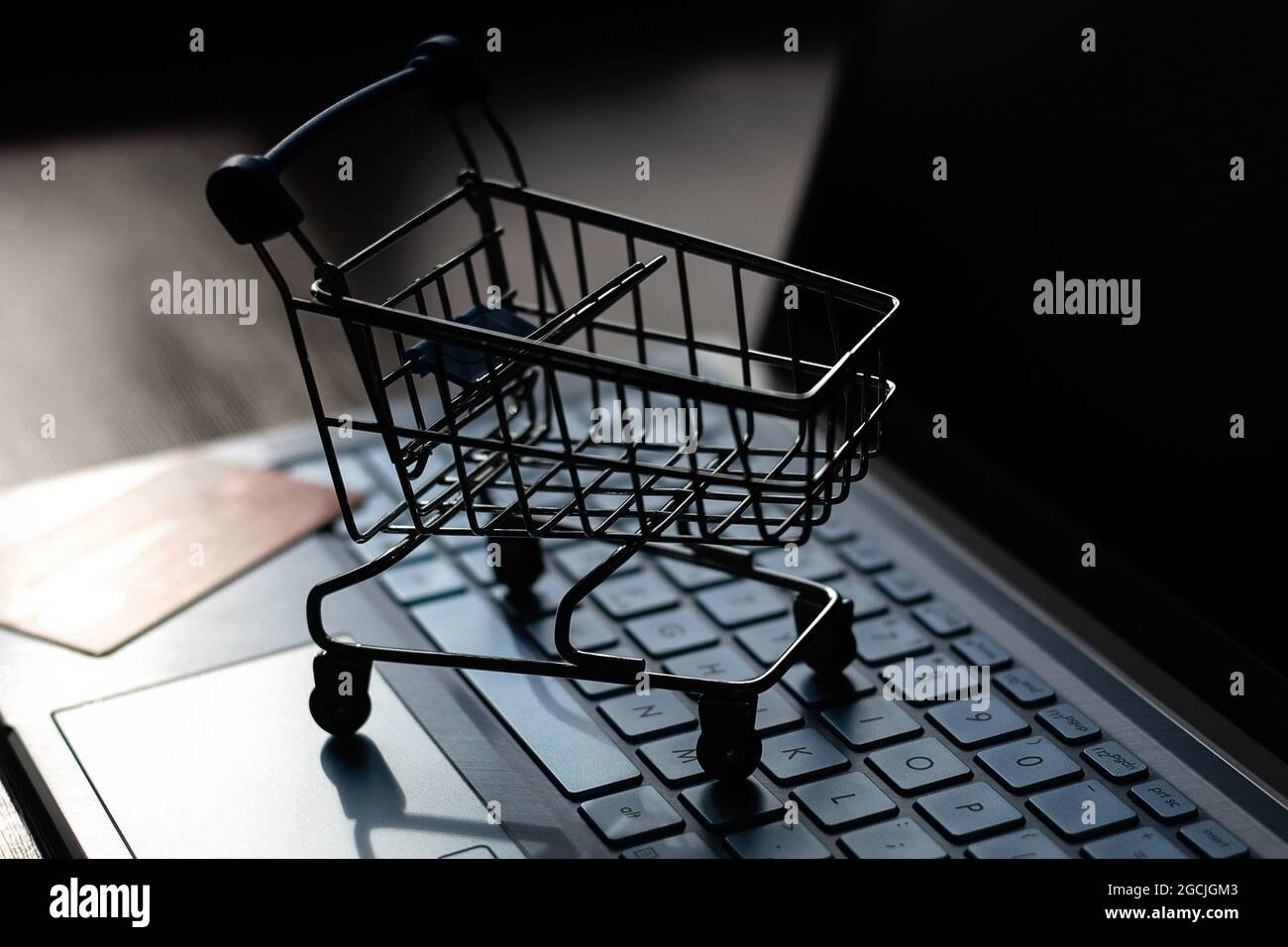 grocery cart on a computer keyboard and credit card, online shopping ...