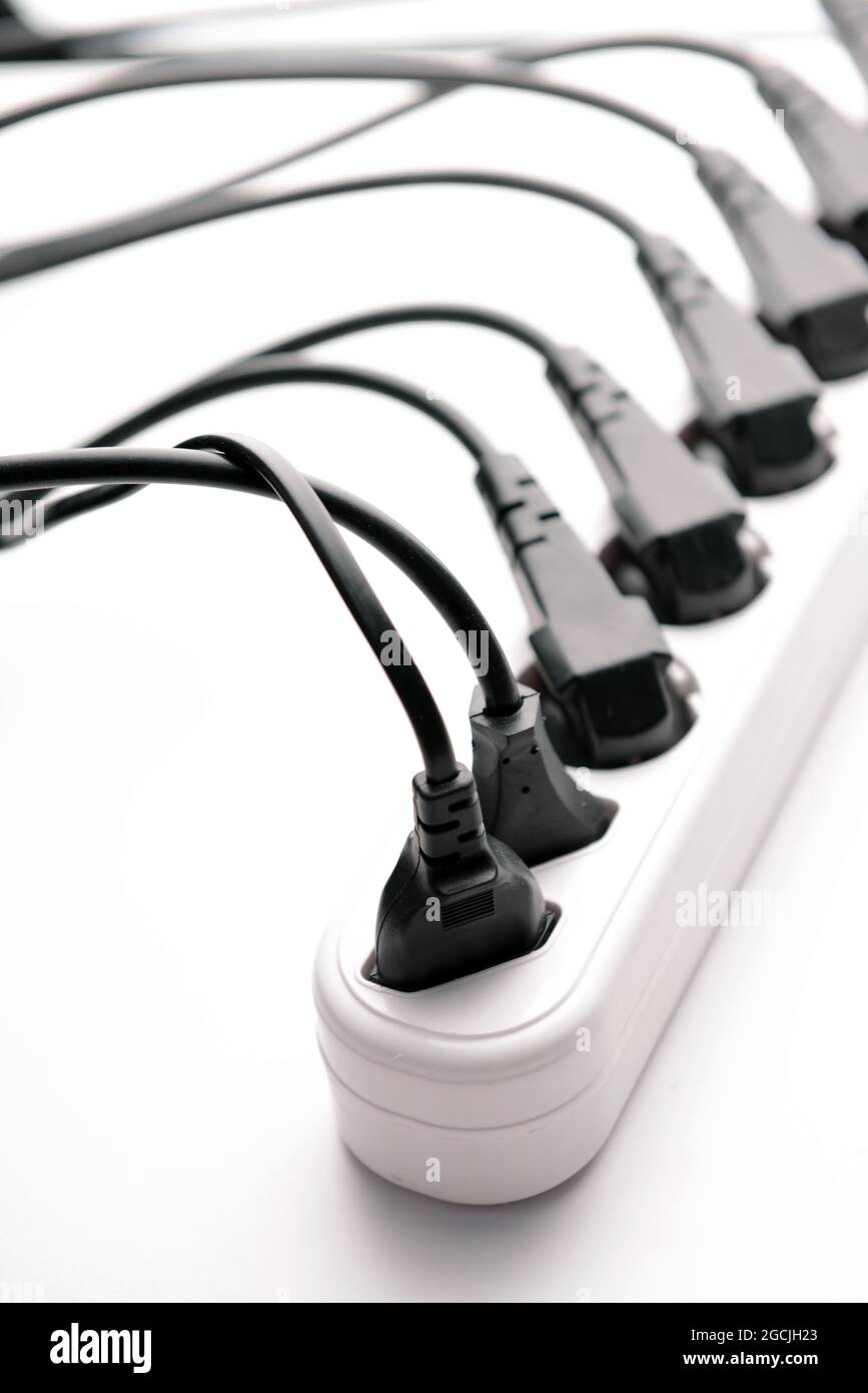 Overloaded power board, isolated on white Stock Photo - Alamy