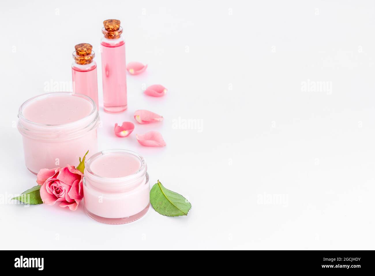 Essential rose aroma oil with cosmetic products for skin care Stock ...