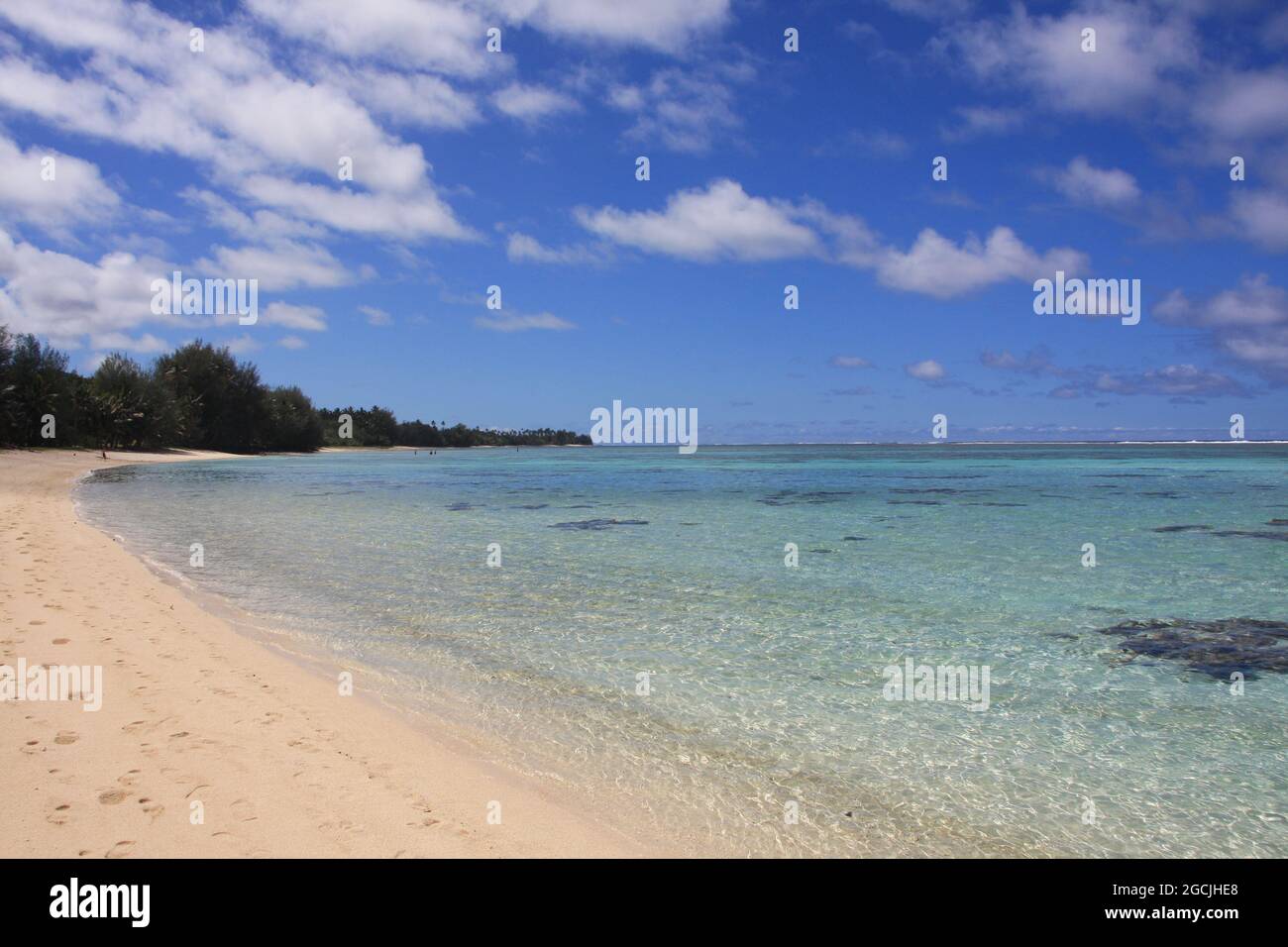 a sandy beach next to a body of water in cook islands Stock Photo - Alamy