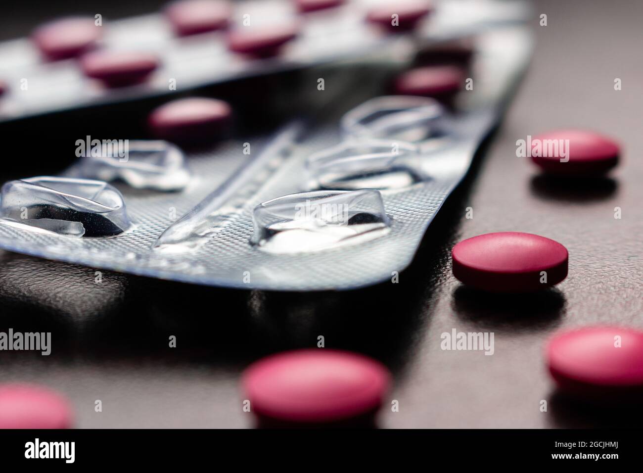 red pills and empty packaging close up Stock Photo - Alamy