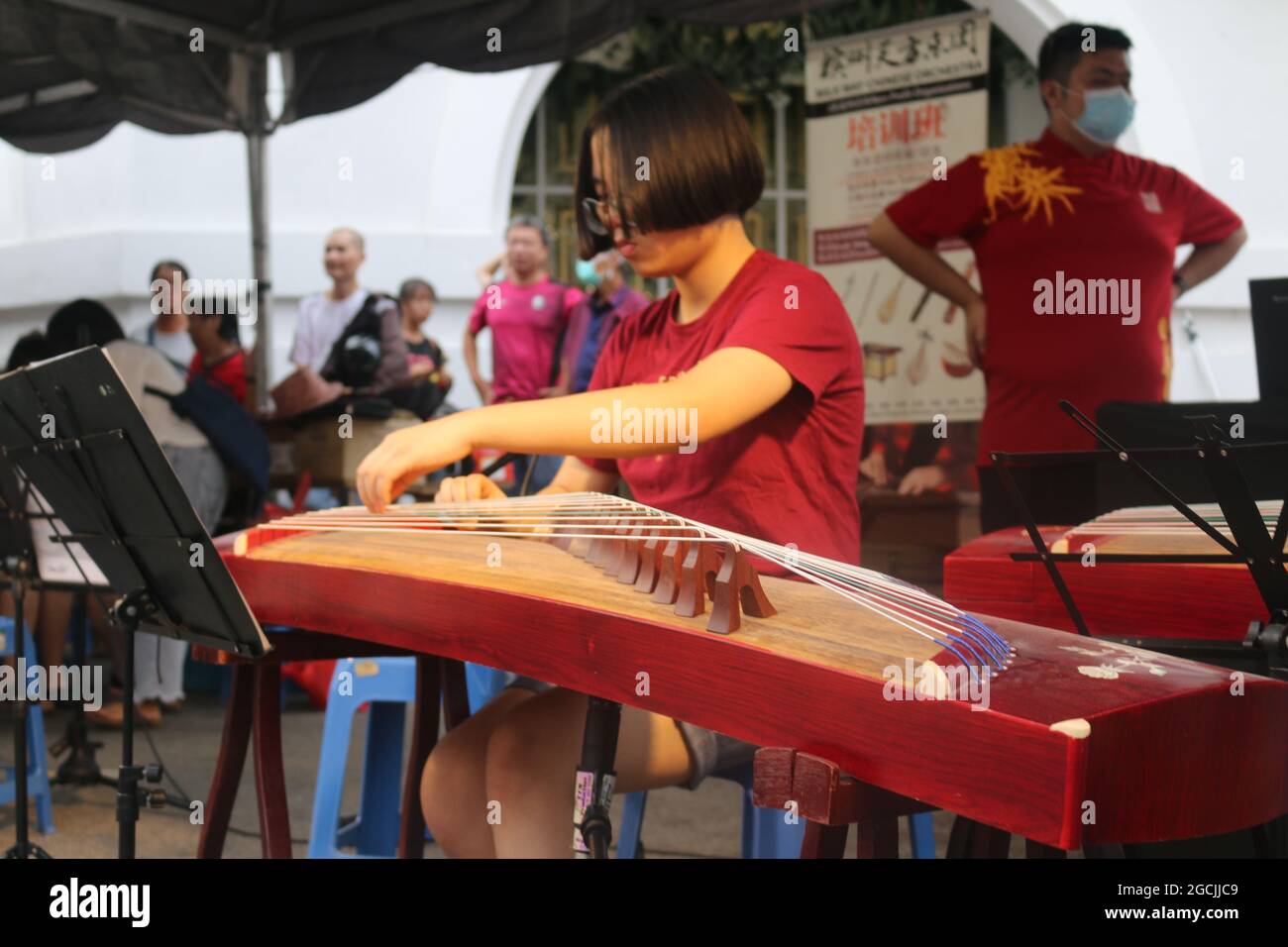 Closeup shot of Chinese woman playing a Chinese instrument on the ...